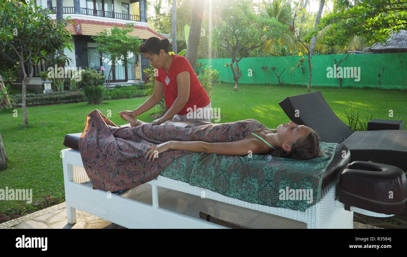 Asian Woman Massage Therapist Doing Massage To Girl Summer Vacation On Luxury Spa Resort