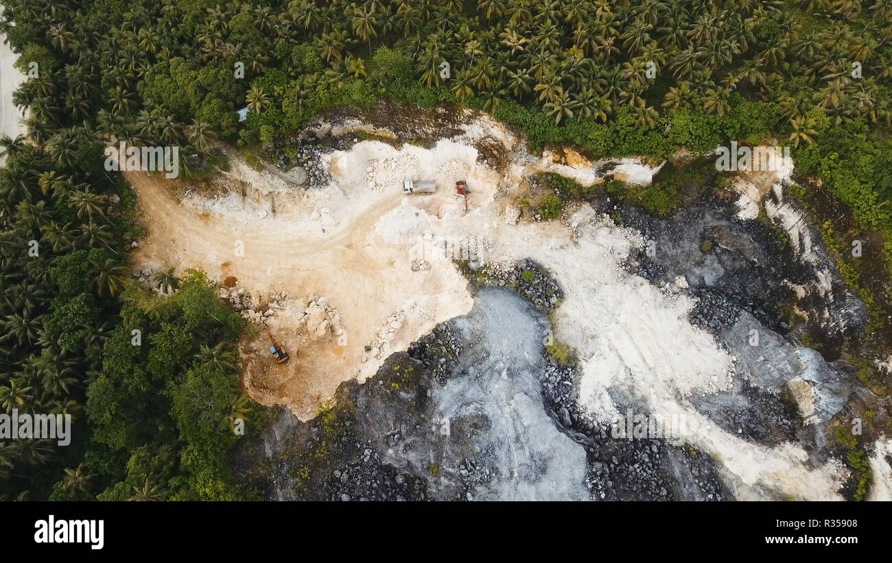 Excavator loads the truck in a limestone quarry. Aerial view wheel ...