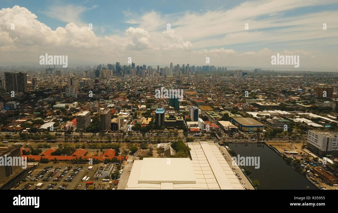 Aerial view of Manila city. Fly over city with skyscrapers and ...