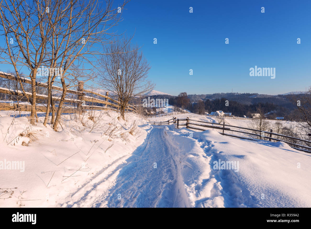 Mountain path in the snow, beautiful winter landscape with blue sky ...