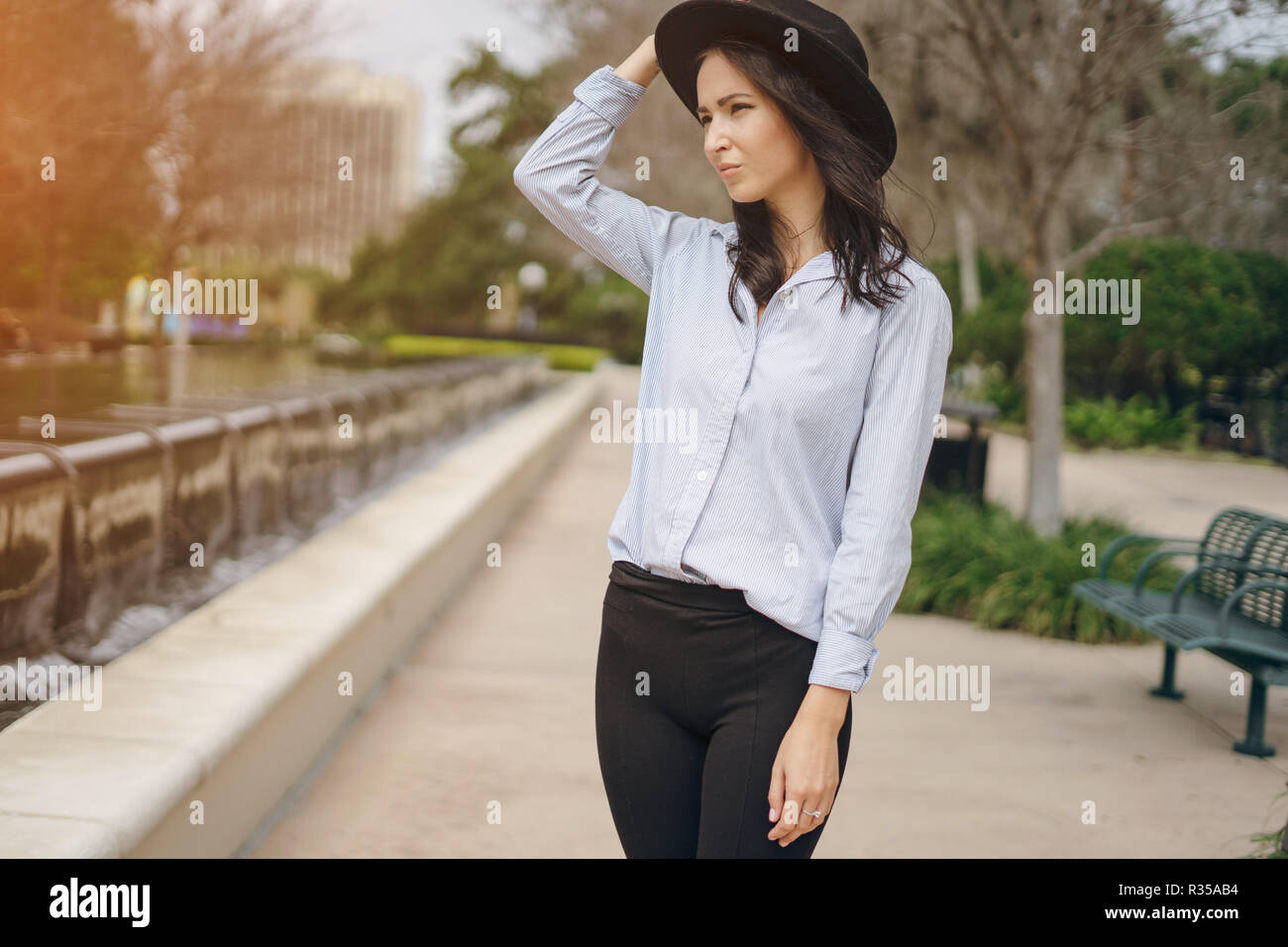 young model brunette on the street in a hat Stock Photo - Alamy