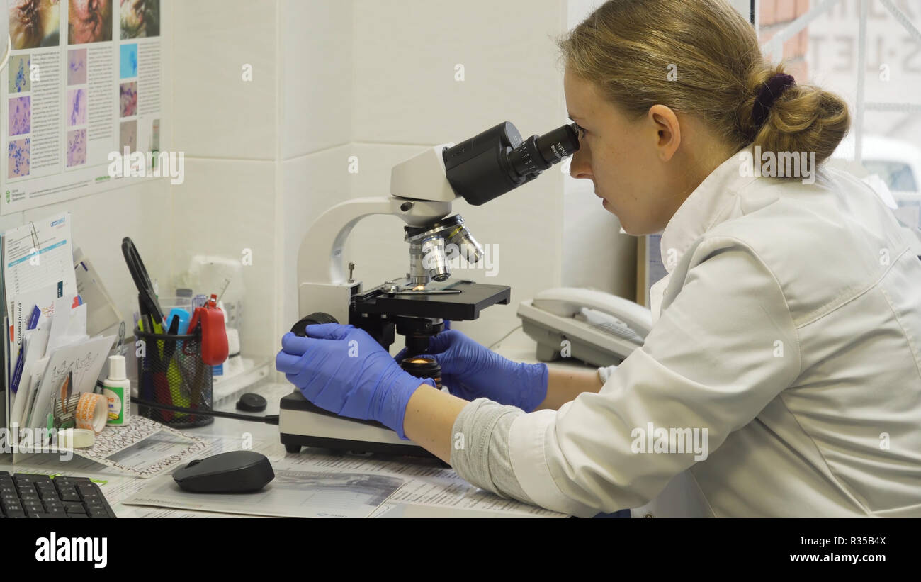 Doctor woman working with a microscope in Laboratory. Female scientist ...