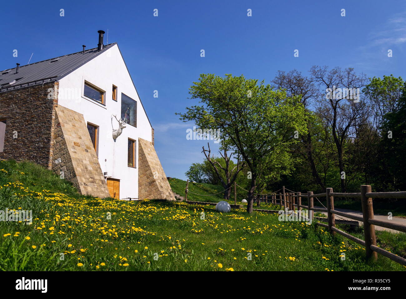 Deer head relief sculpture on facade of beautiful white village ...
