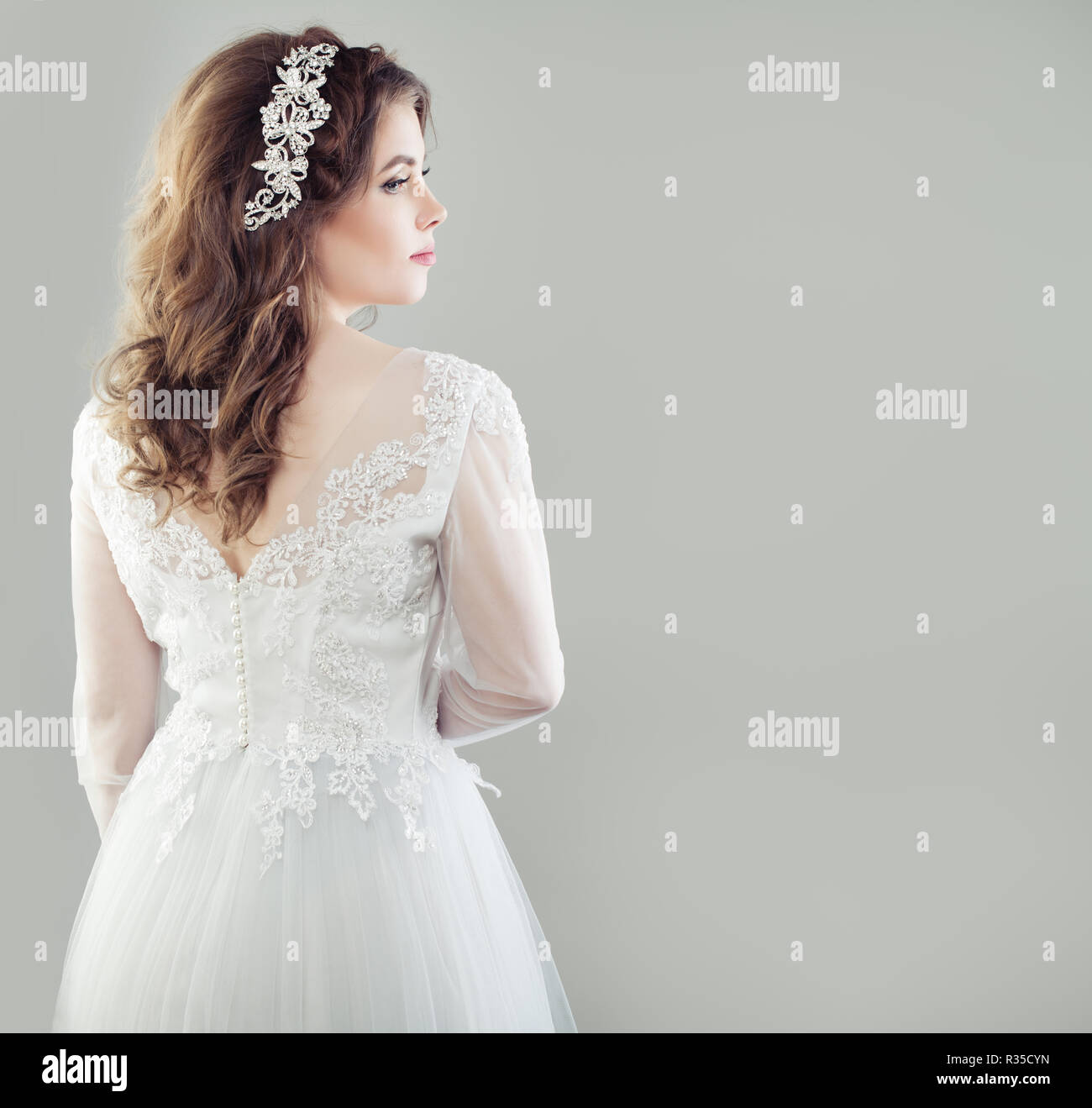 Glamorous young bride woman in white bridal dress, female back and ...