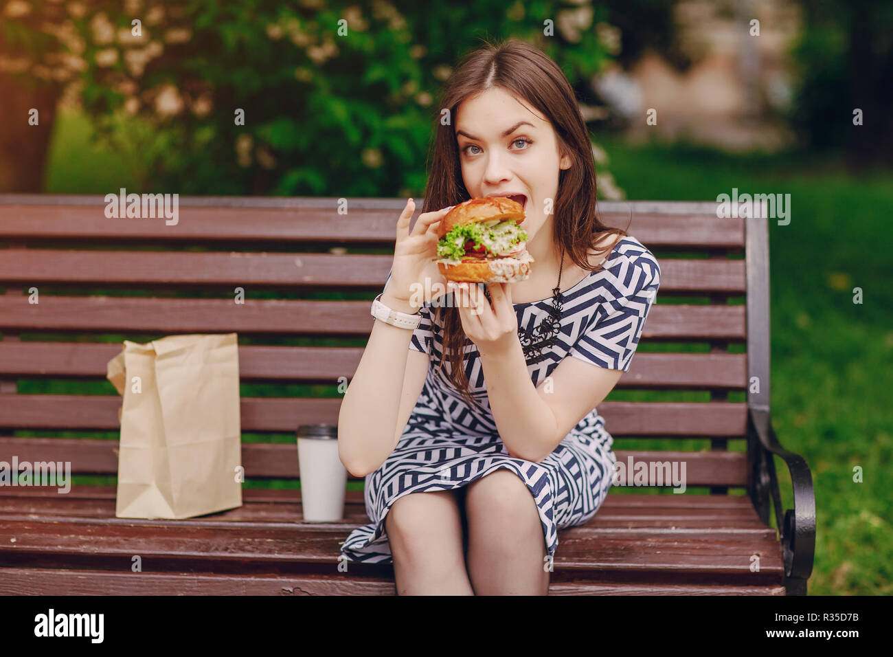 Young woman eating burger model hi-res stock photography and images - Alamy