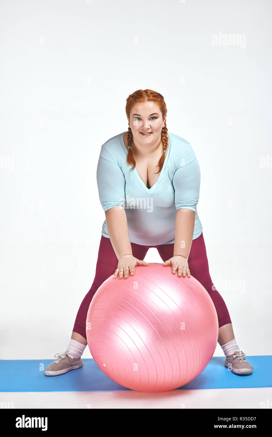 Funny picture of amusing, red haired, chubby woman which is holding a ...