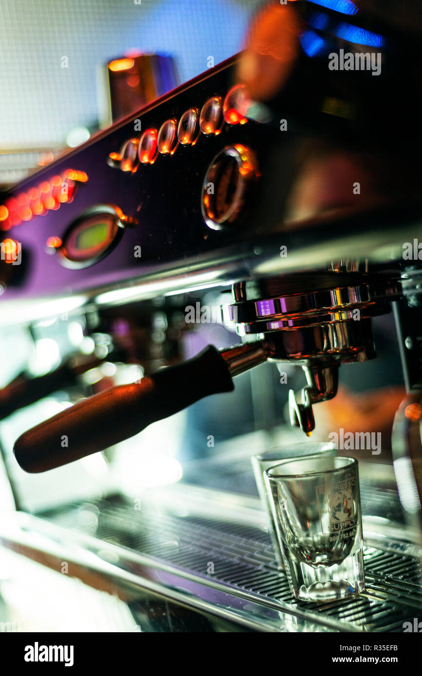 making espresso coffee close up detail with glasses and modern cafe ...