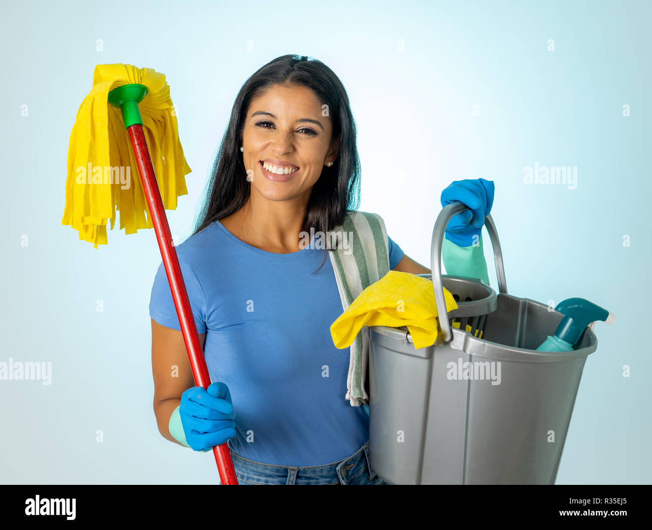 Beautiful happy latin woman holding cleaning equipment in Cleaning ...