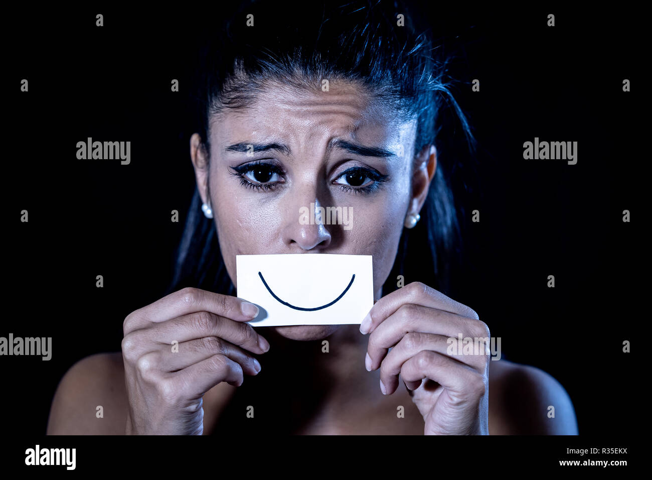 Dramatic close up portrait of sad woman hiding her depression with ...