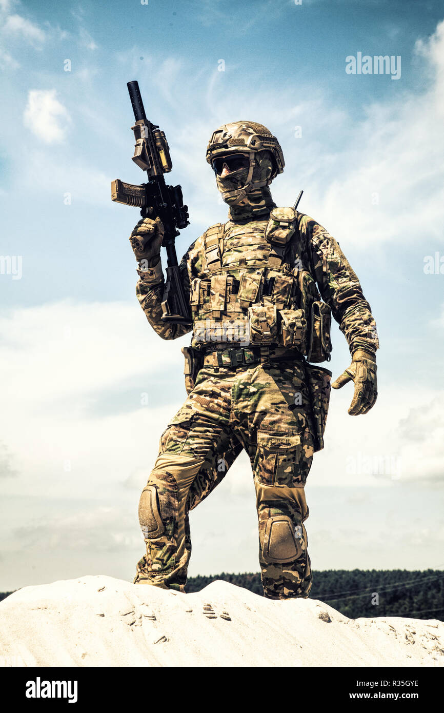 Man in military camouflage uniform and mask, equipped tactical ...