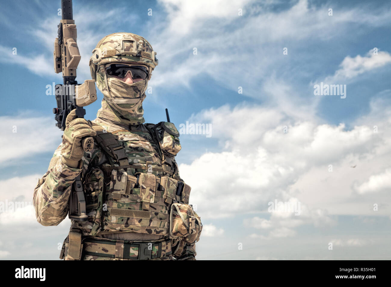 Half-length portrait of airsoft game player in army camouflage uniform ...