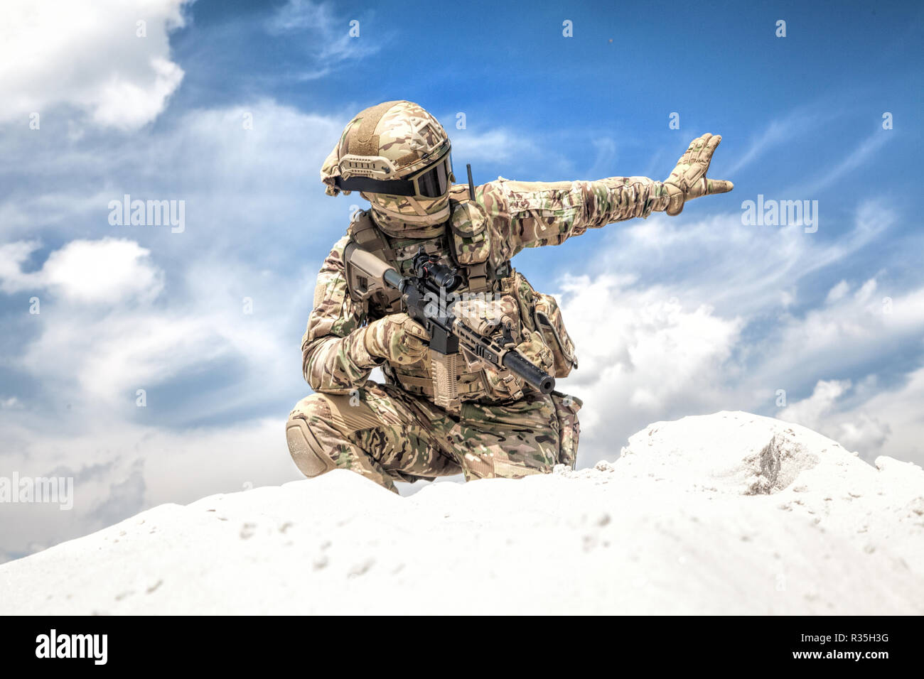 Army soldier or airsoft player in camo uniform and helmet, armed ...