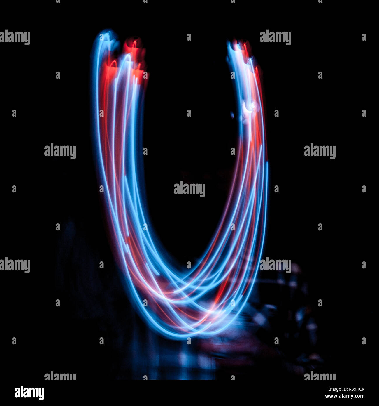 Letter U of the alphabet made from neon sign. The blue light image ...