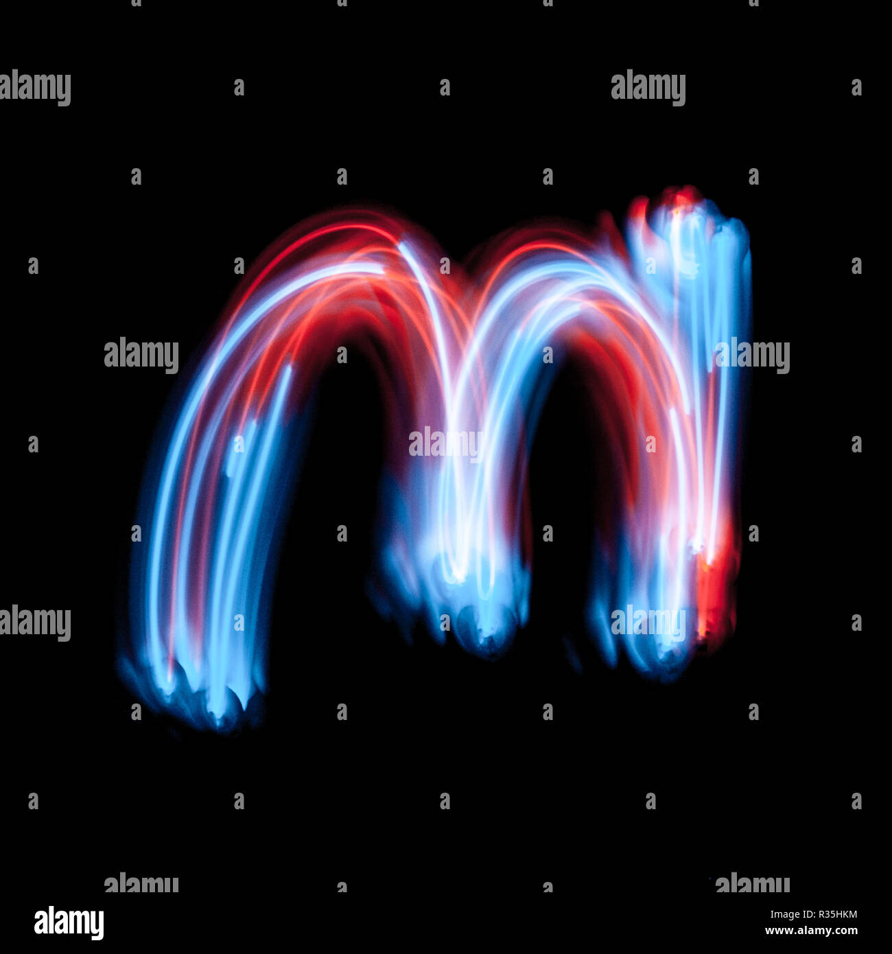 Letter M of the alphabet made from neon sign. The blue light image ...