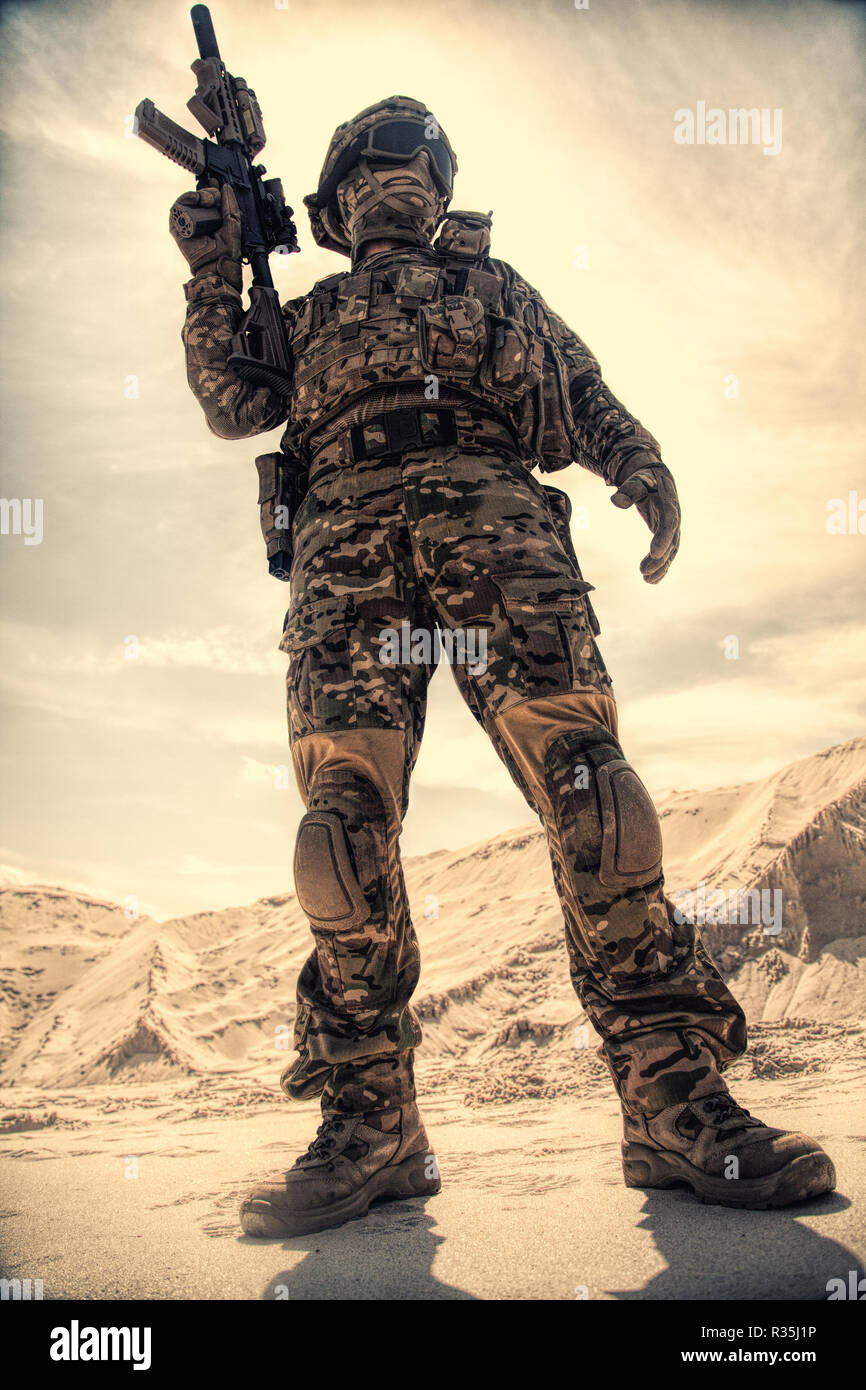 Airsoft player in U.S. army uniform, helmet, mask and glasses standing ...