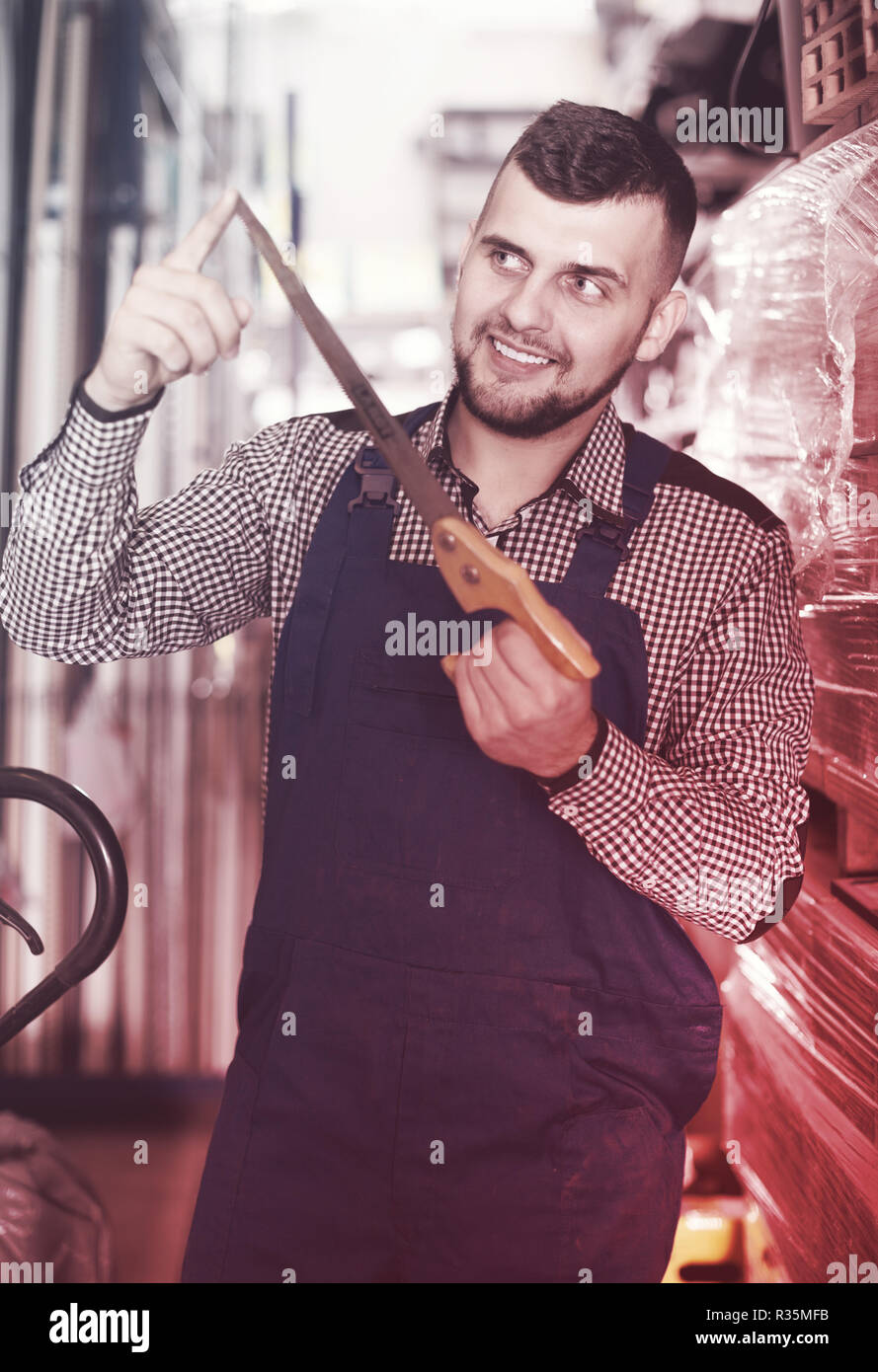 Young man worker showing his constructing tools at workshop Stock Photo ...