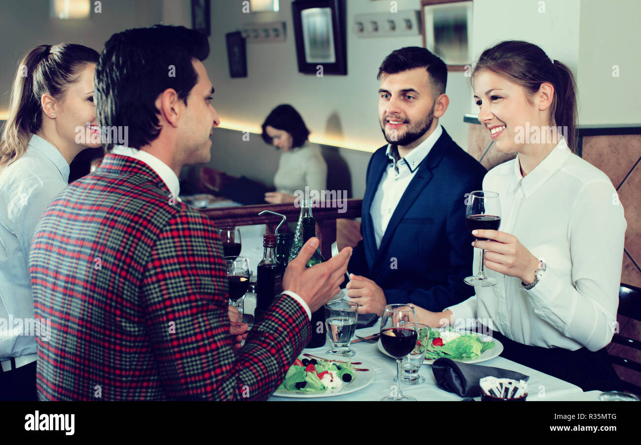 Cheerful friendly meeting over dinner with wine in restaurant Stock ...