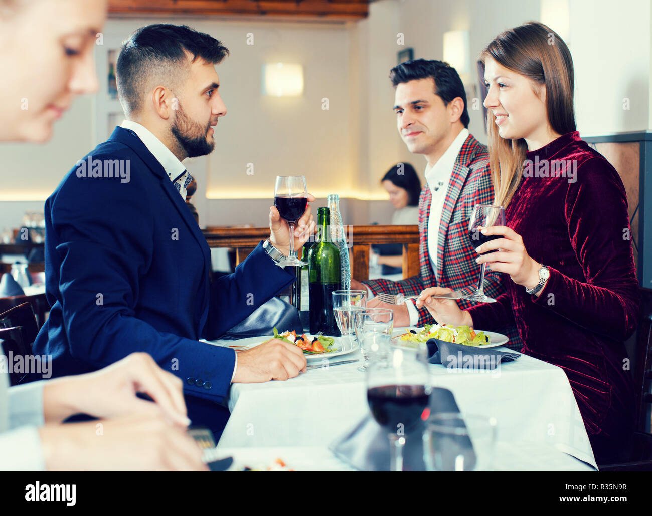 Friendly meeting over dinner with wine in restaurant Stock Photo - Alamy