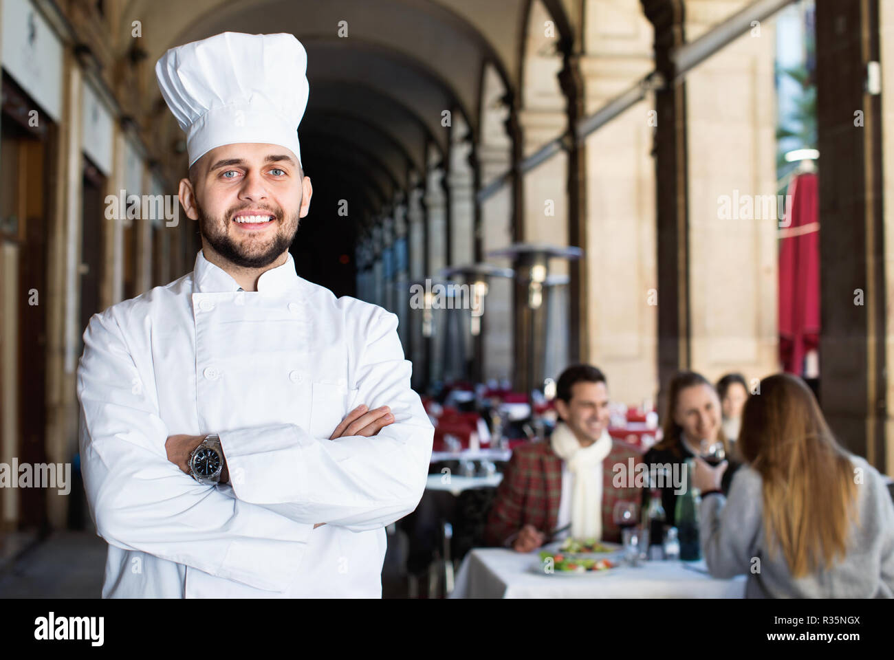 Confident glad chef of restaurant posing with arms crossed Stock Photo ...