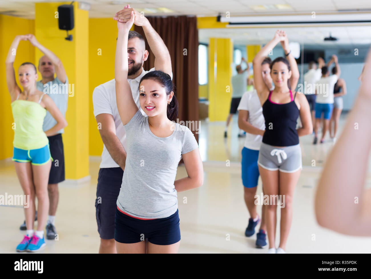 Young sporty spanish girls and men learning salsa steps Stock Photo - Alamy