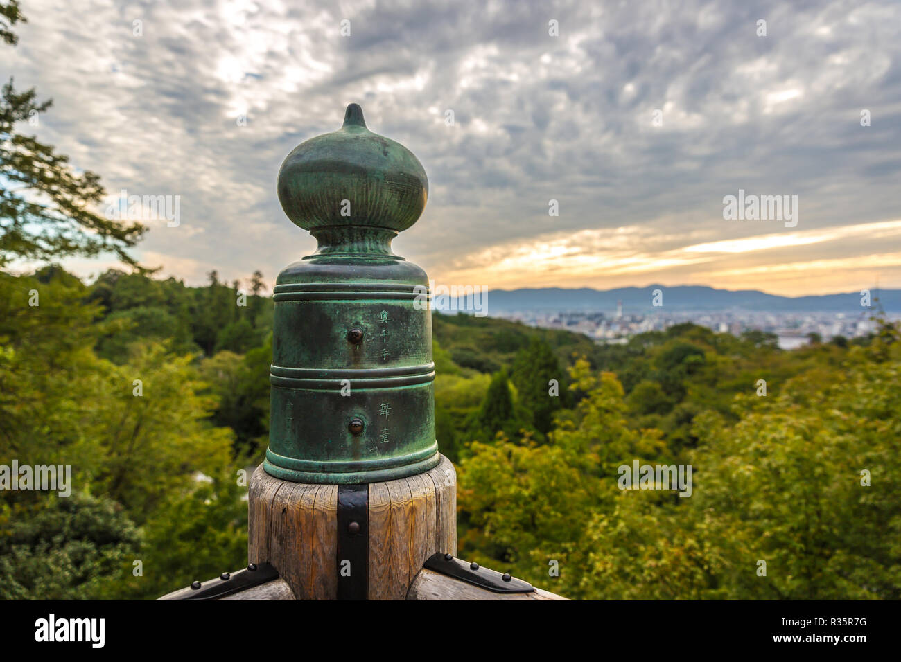 A japanese temple detail over a huge green forest in a cloud day in ...