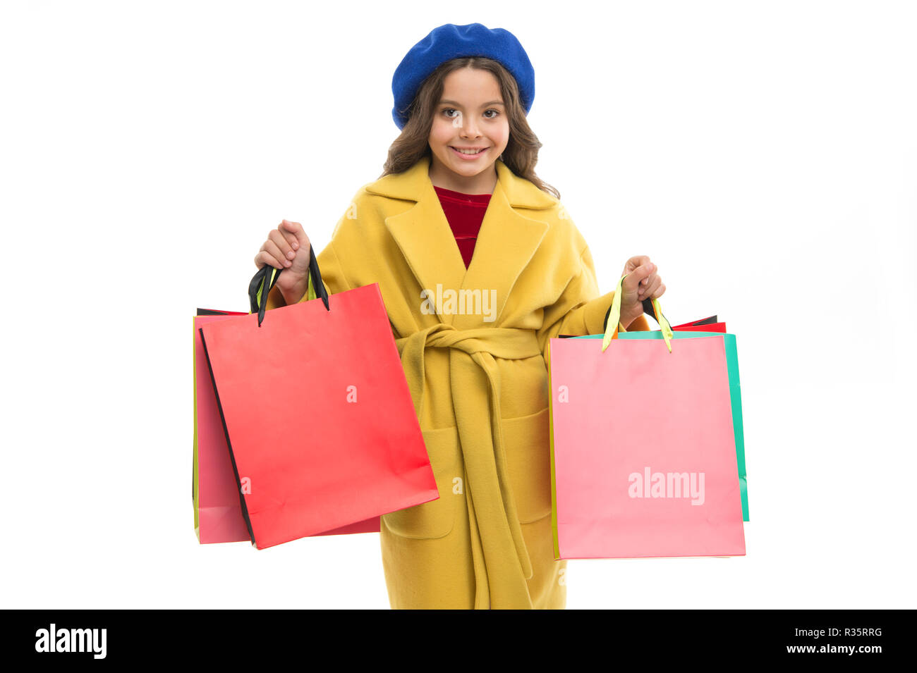 Kid cute little girl hold bunch shopping bags. Child satisfied by ...