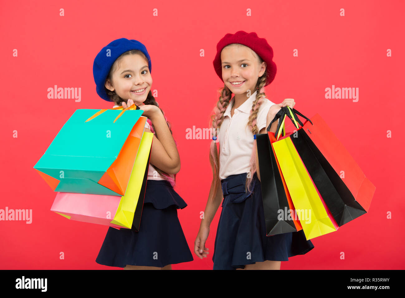 Shopping become fun with best friends. Kids cute schoolgirls hold bunch ...