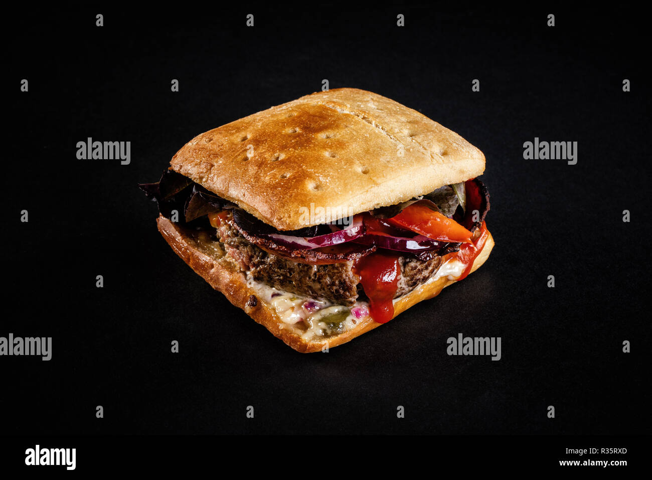 Burger isolated in black background Stock Photo - Alamy