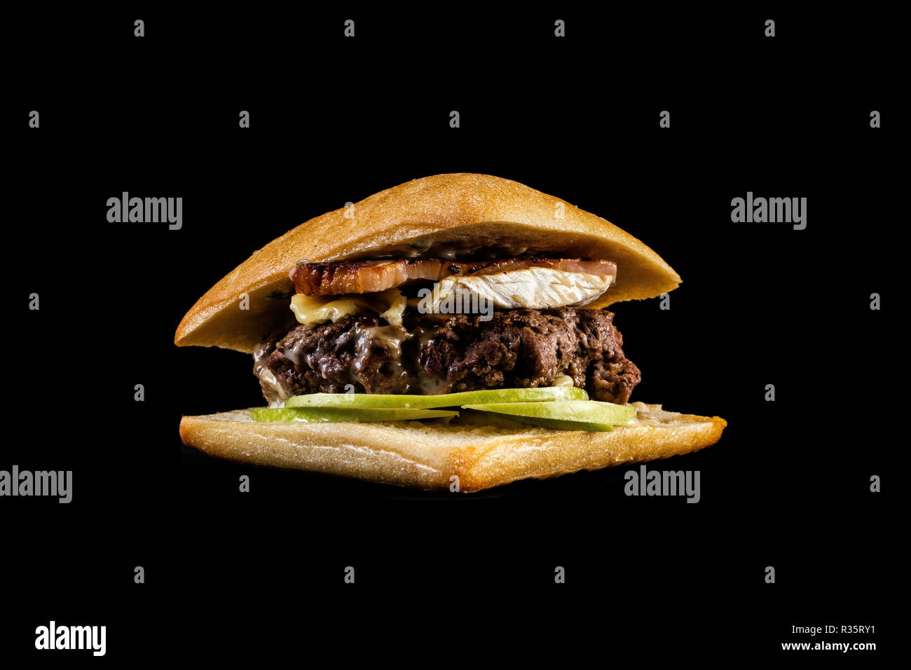 Burger isolated in black background Stock Photo - Alamy