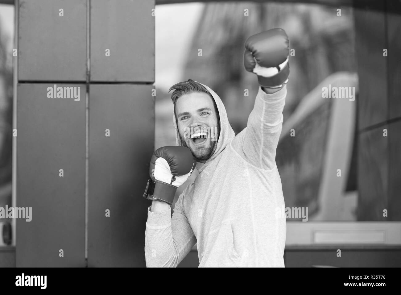 Winner takes it all. Man on smiling face posing with boxing gloves as ...