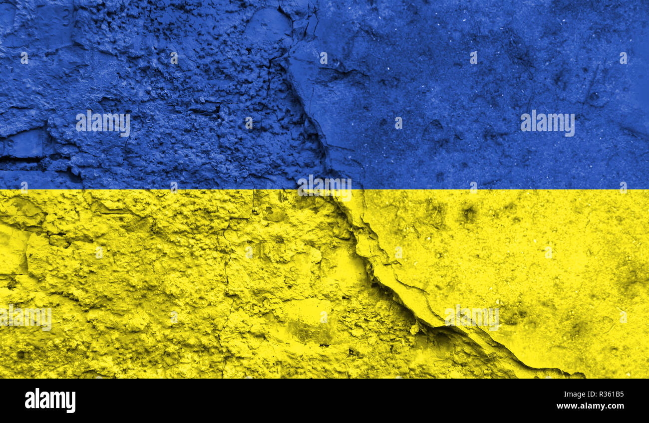 Flag of Ukraine close up painted on a cracked wall, concept of armed ...
