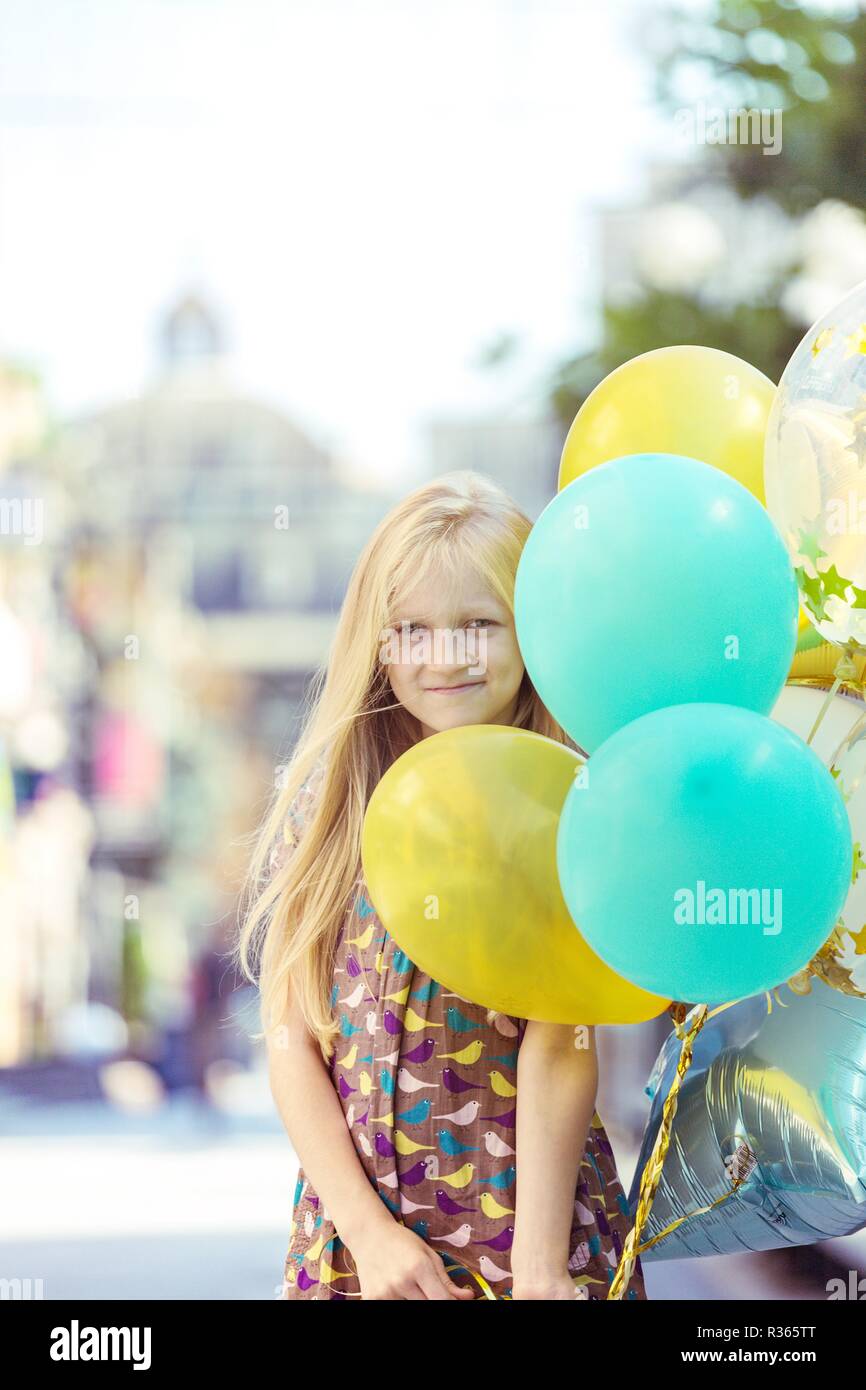 Happy girl with colorful balloons Stock Photo - Alamy