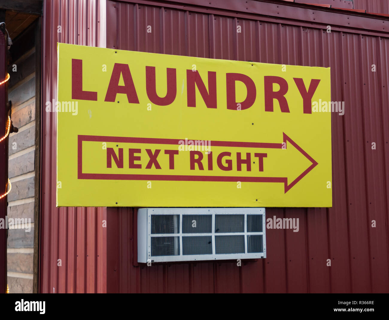 Laundry Next Right Sign Hanging on Red Building Stock Photo - Alamy
