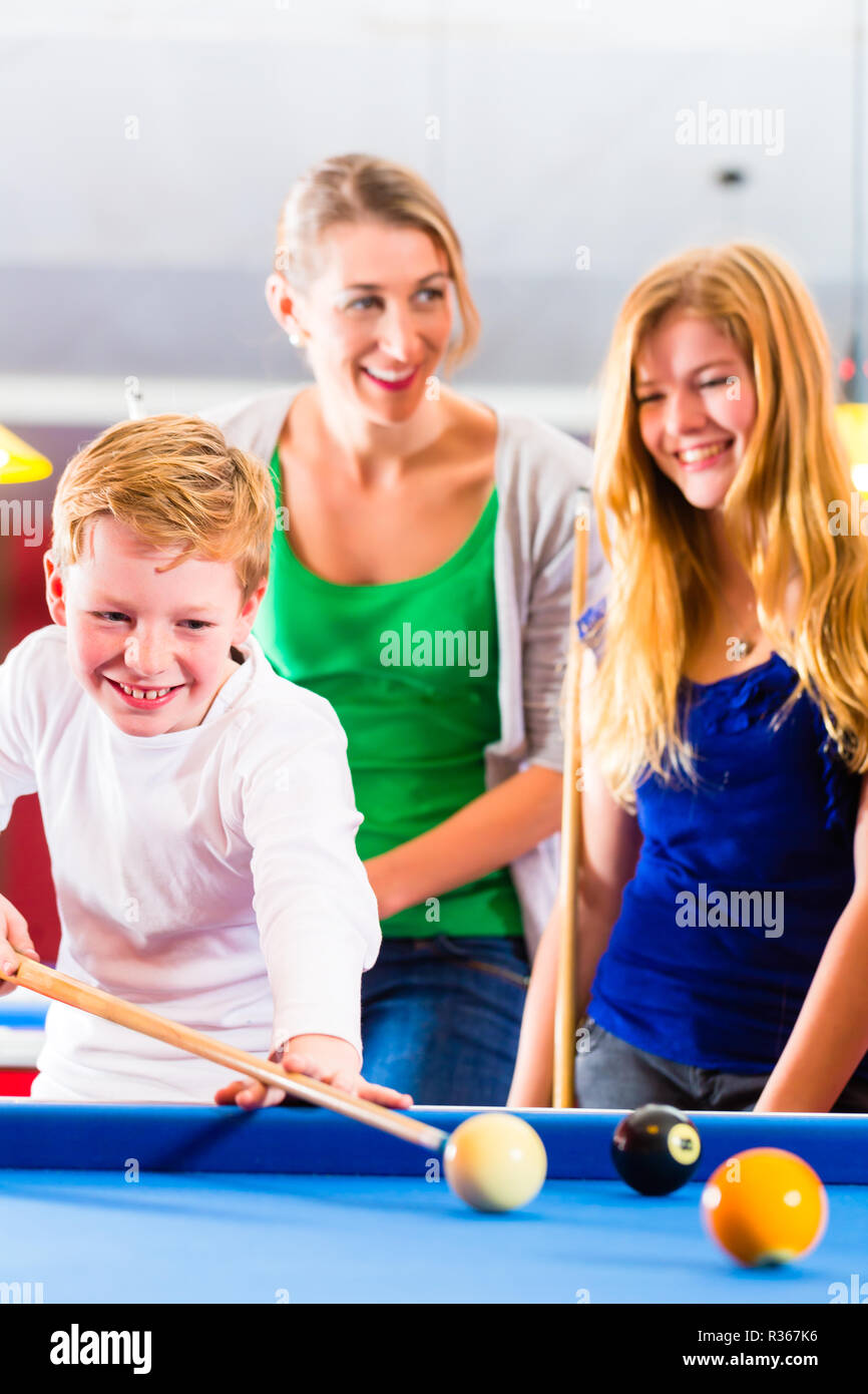boy playing billiards with family Stock Photo - Alamy