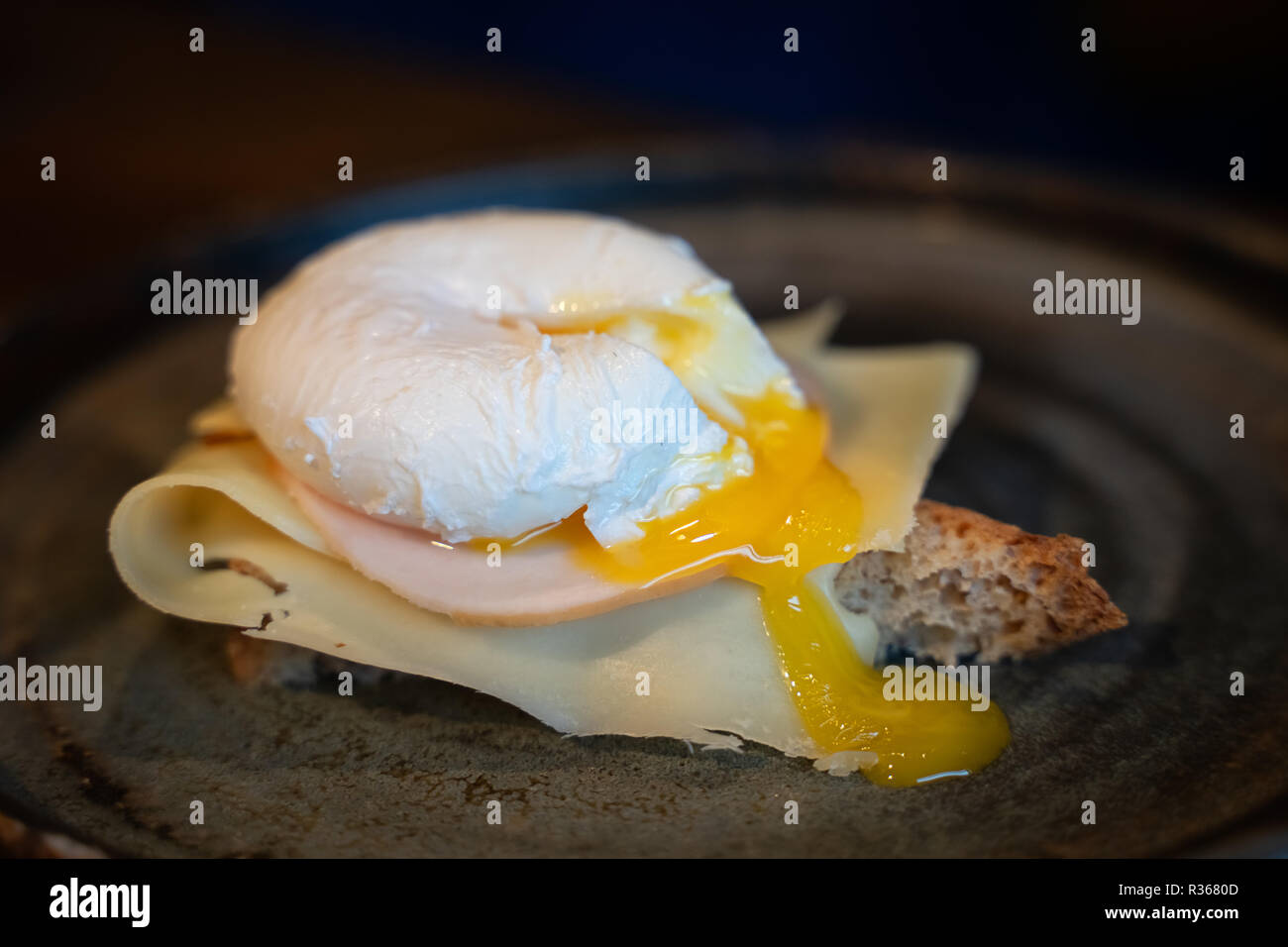 Whole wheat toasted bread with cheese, ham and poached egg Stock Photo ...