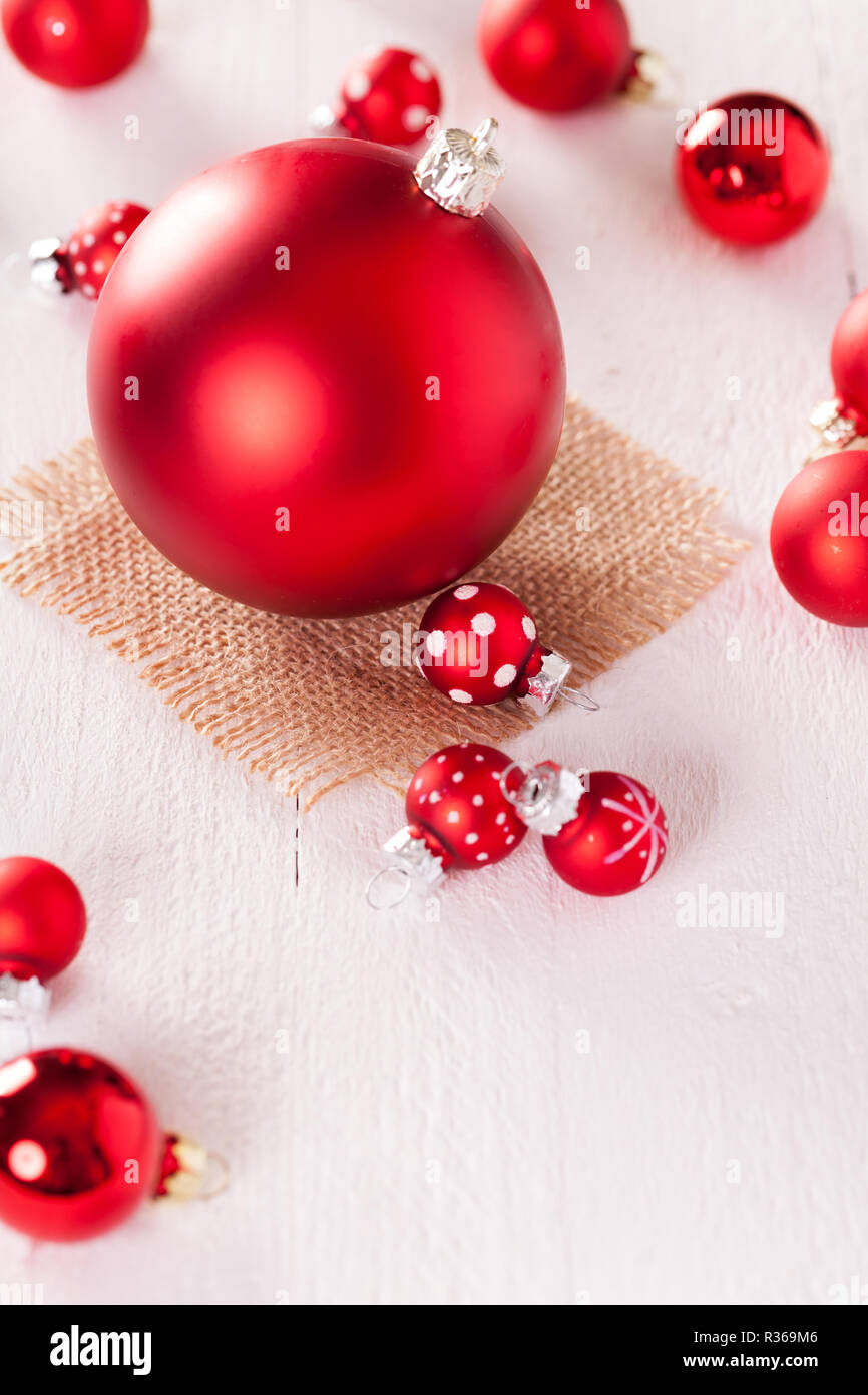 large and small red baubles on a wooden board with a jute sack Stock ...