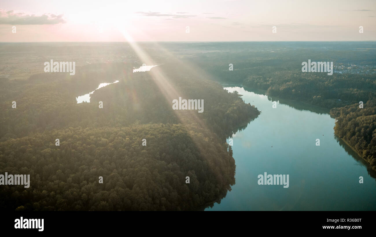 Drone view of forest and lake during sunset Stock Photo - Alamy