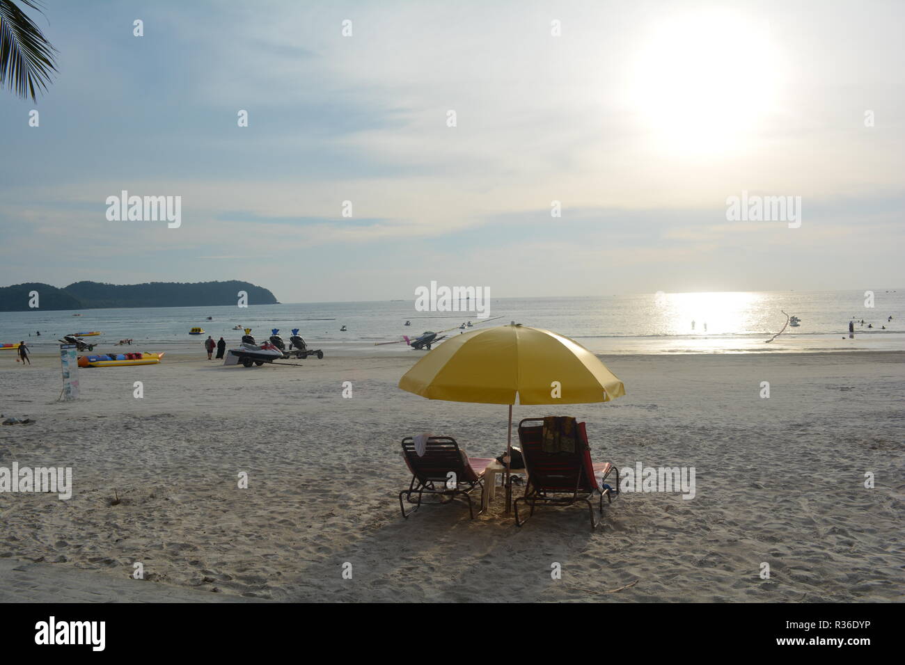 Beach view with sun Stock Photo - Alamy