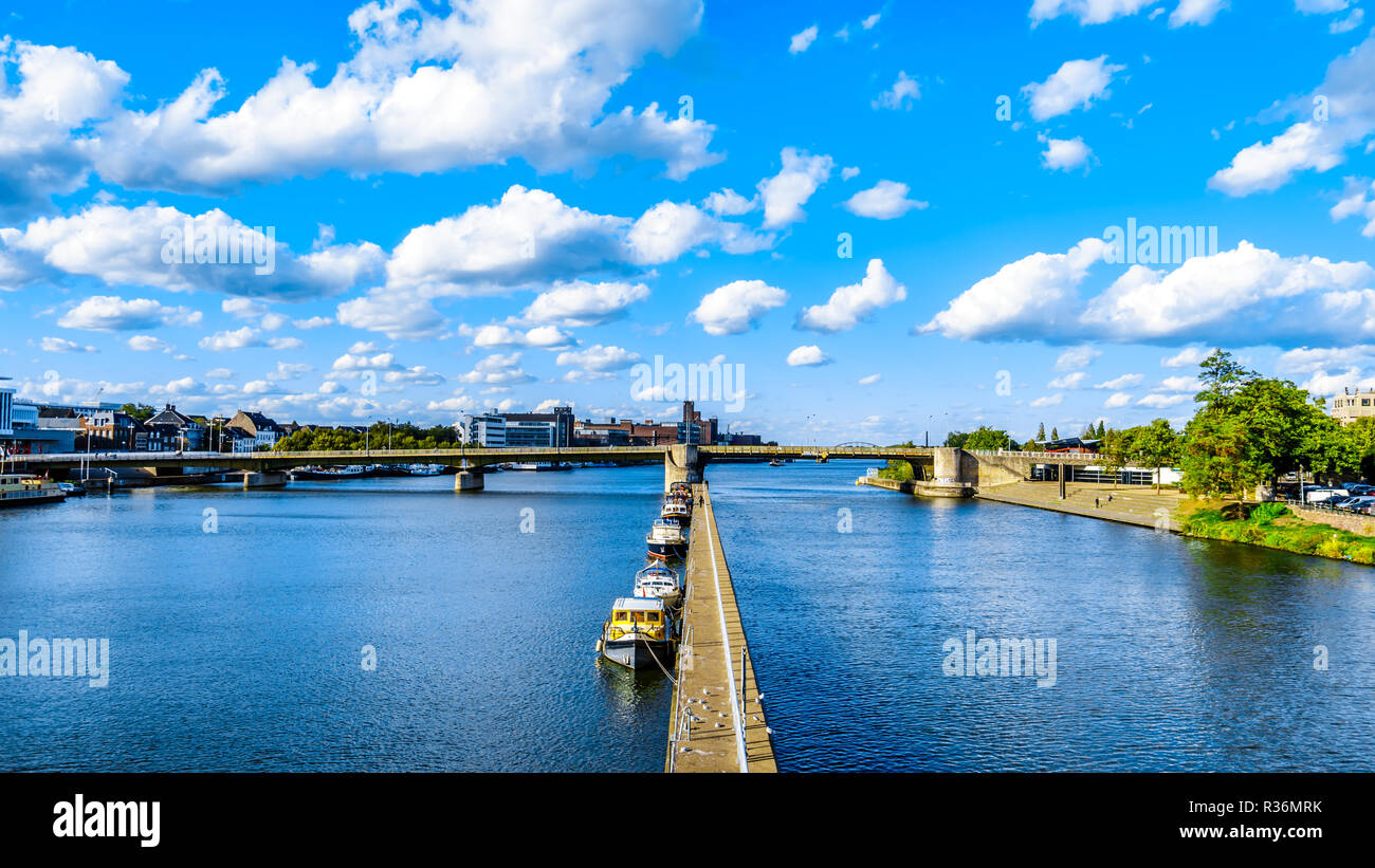 The Maas River (Meuse) as it flows through the historic city of ...
