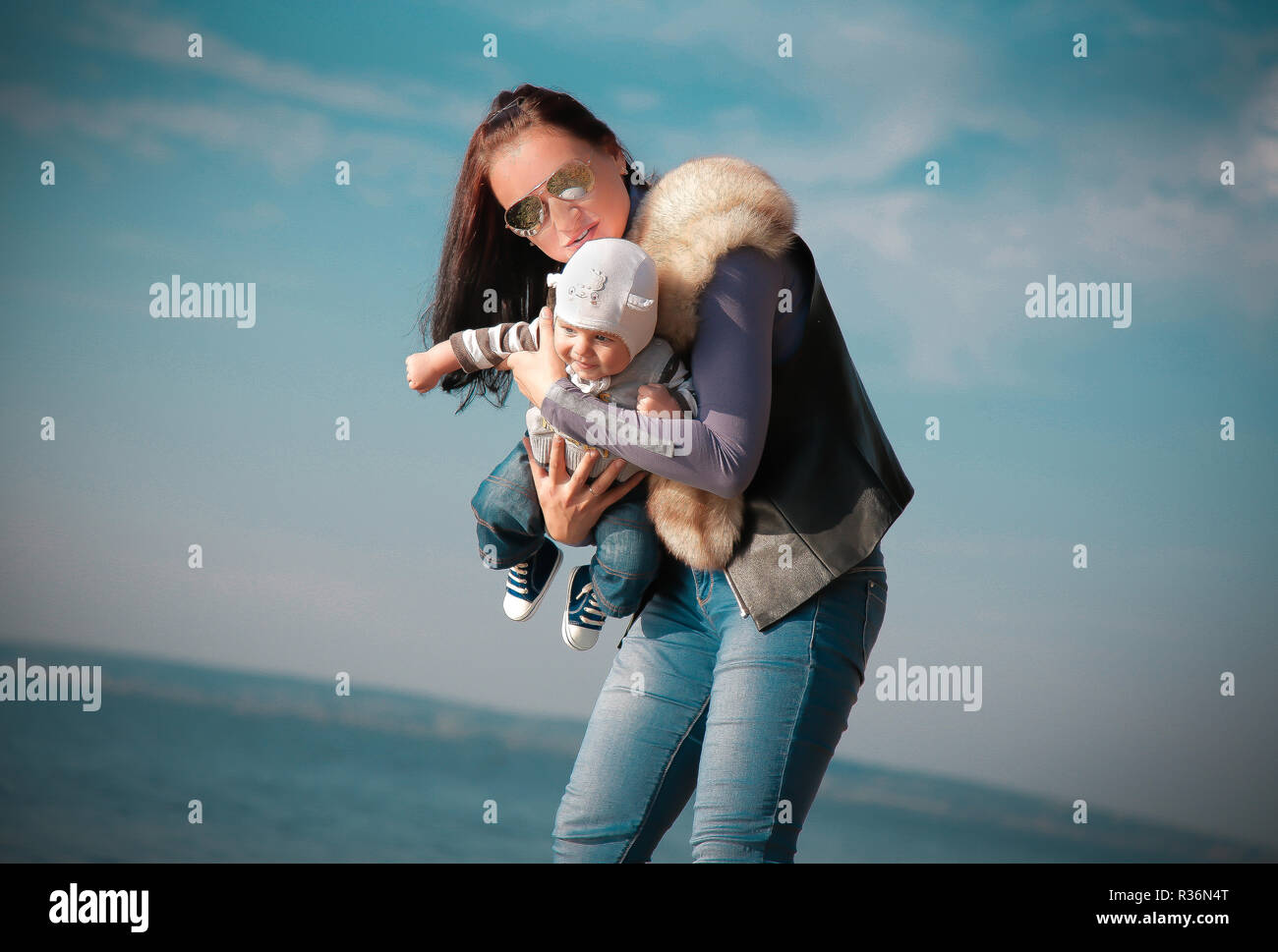 Mom and son have fun on the shore of the blue sea Stock Photo - Alamy