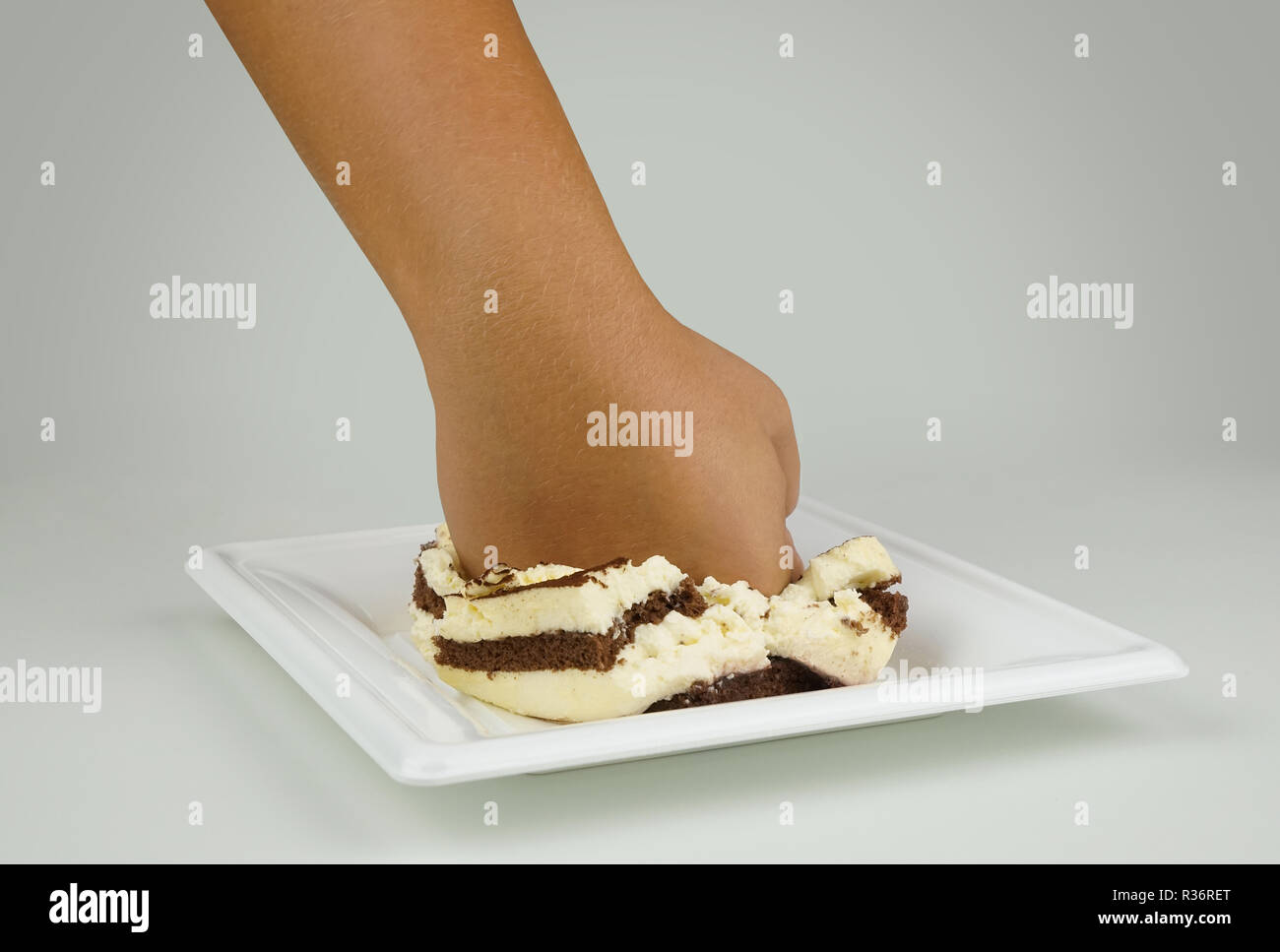 Female fist with a finger down. Fist down on the background of cake ...