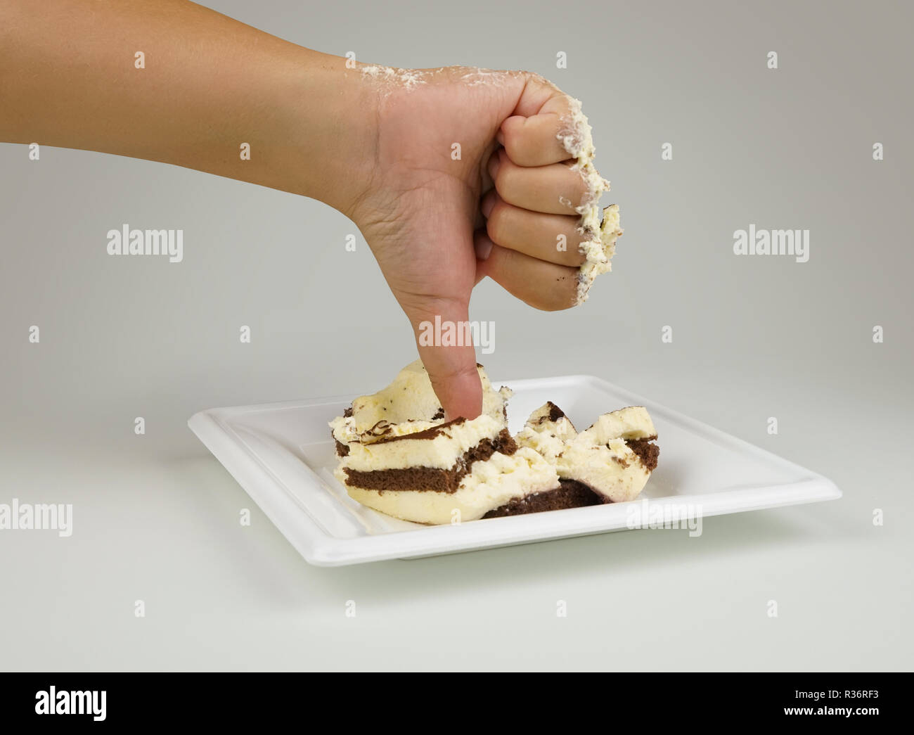 Female hand with finger down. Thumbs down on background of cake. Not ...