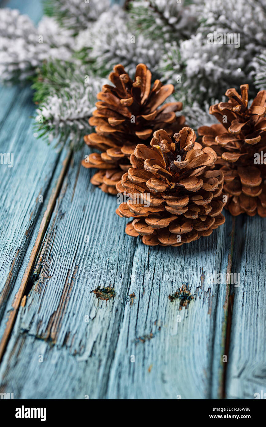 Christmas or New year festive background with pine cones on blue wood ...