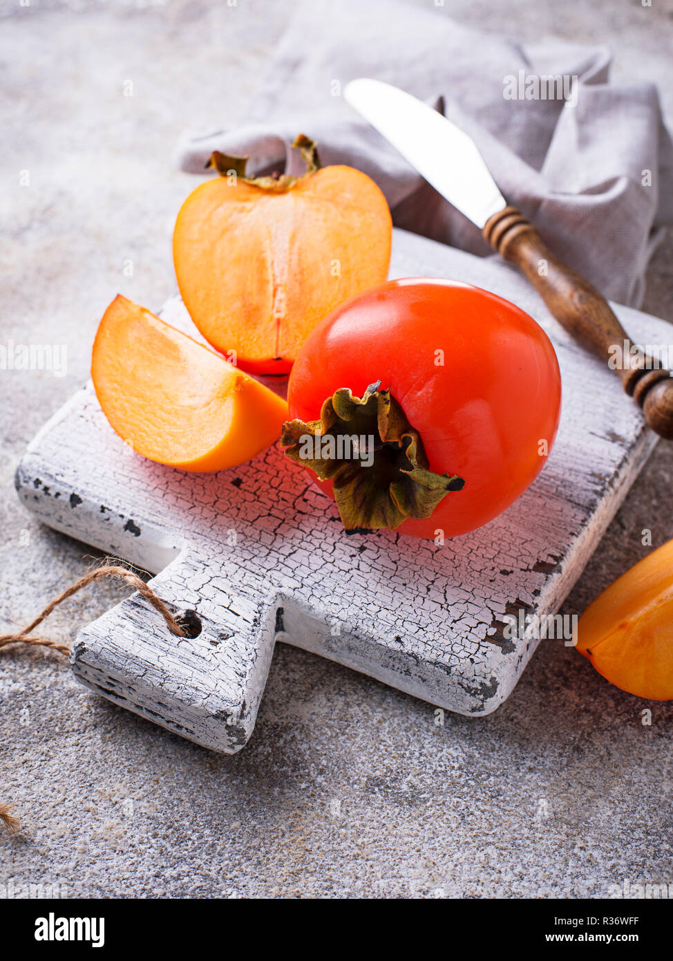 Fresh ripe persimmon on white cutting board Stock Photo - Alamy