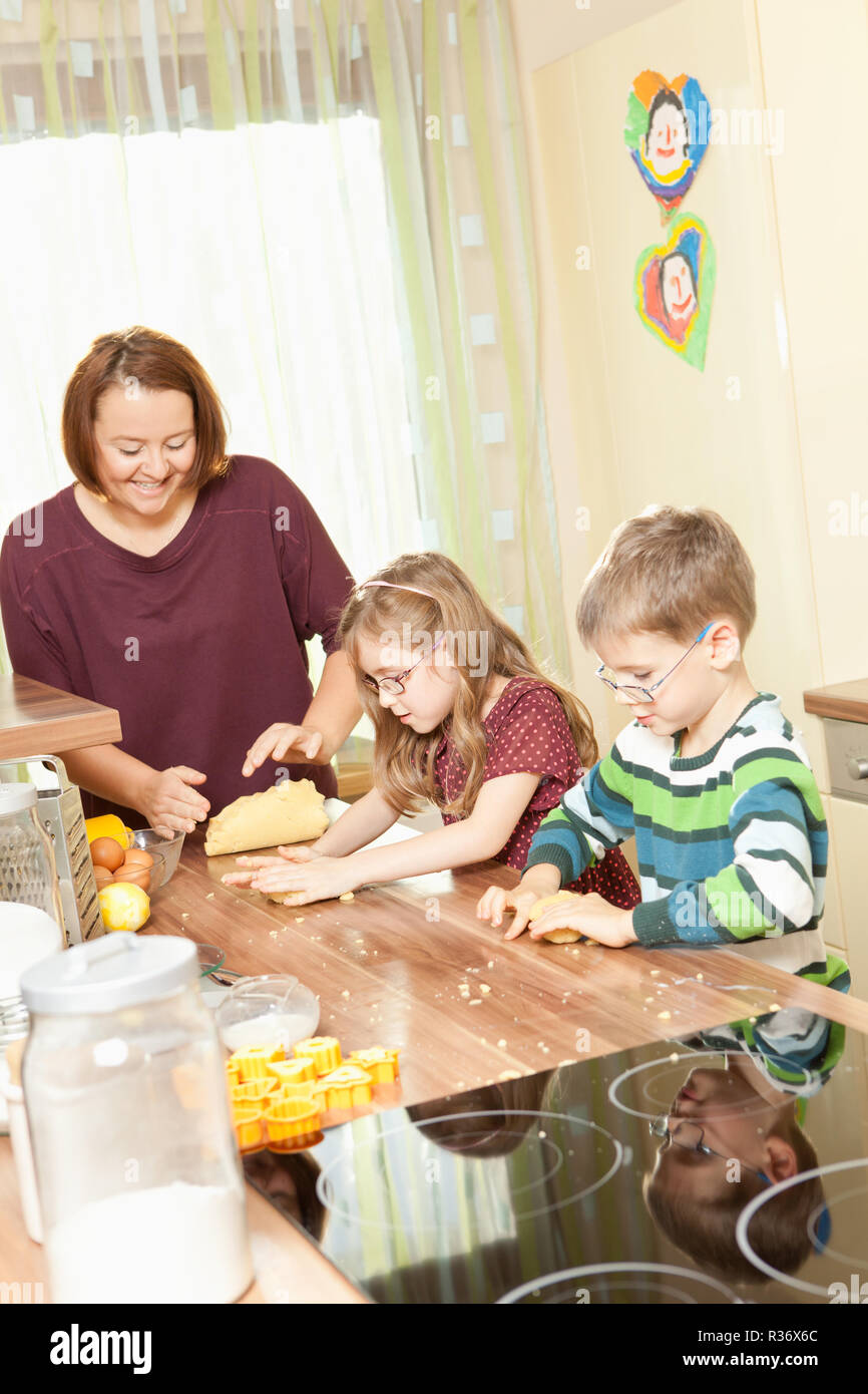 mother bakes cookies with her children Stock Photo - Alamy