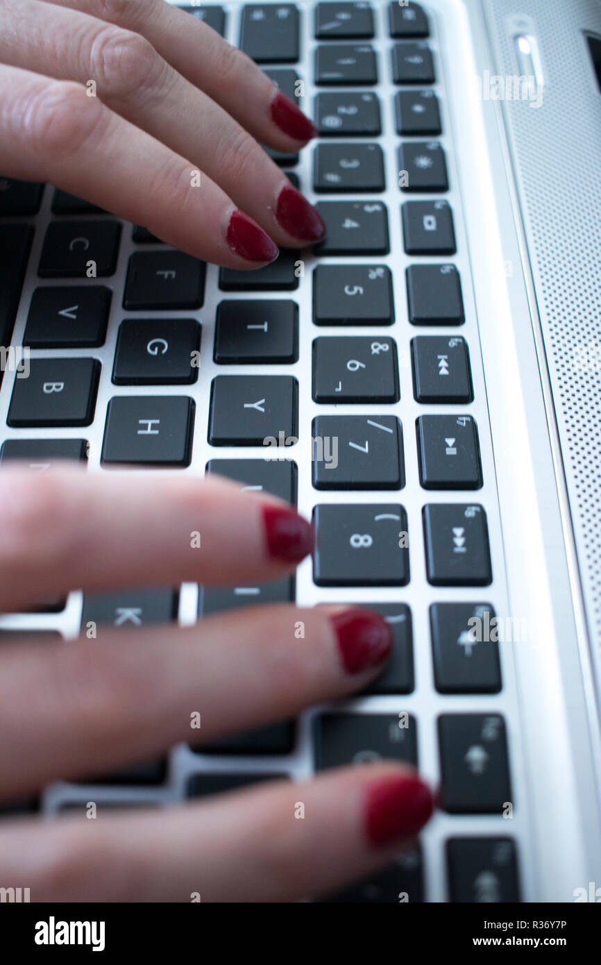 Secretary typist typing on laptop pc computer keyboard keys with hands ...