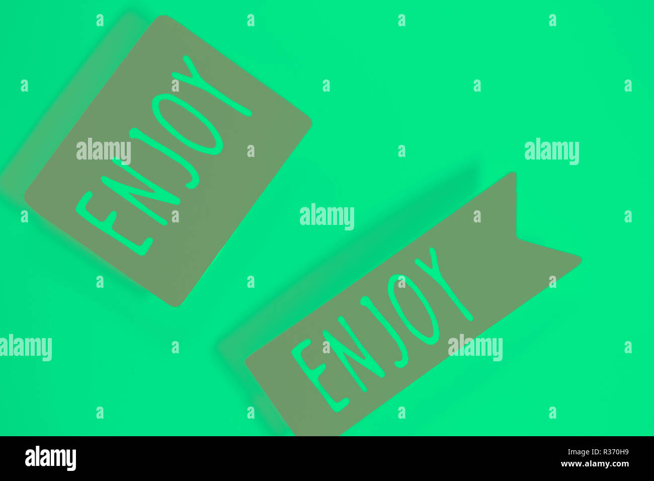 Enjoy greetings message written in letters on present tag Stock Photo ...