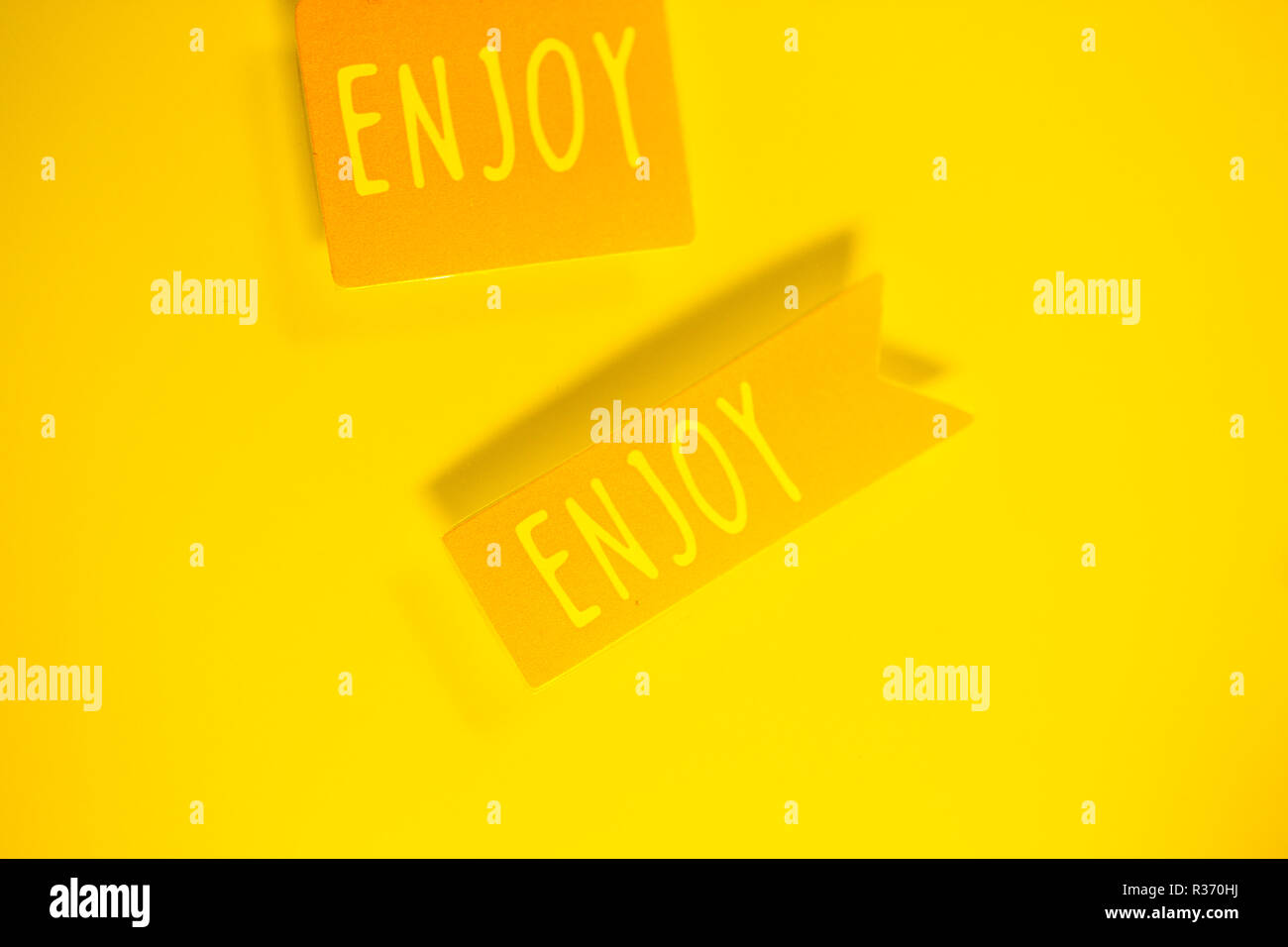 Enjoy greetings message written in letters on present tag Stock Photo ...