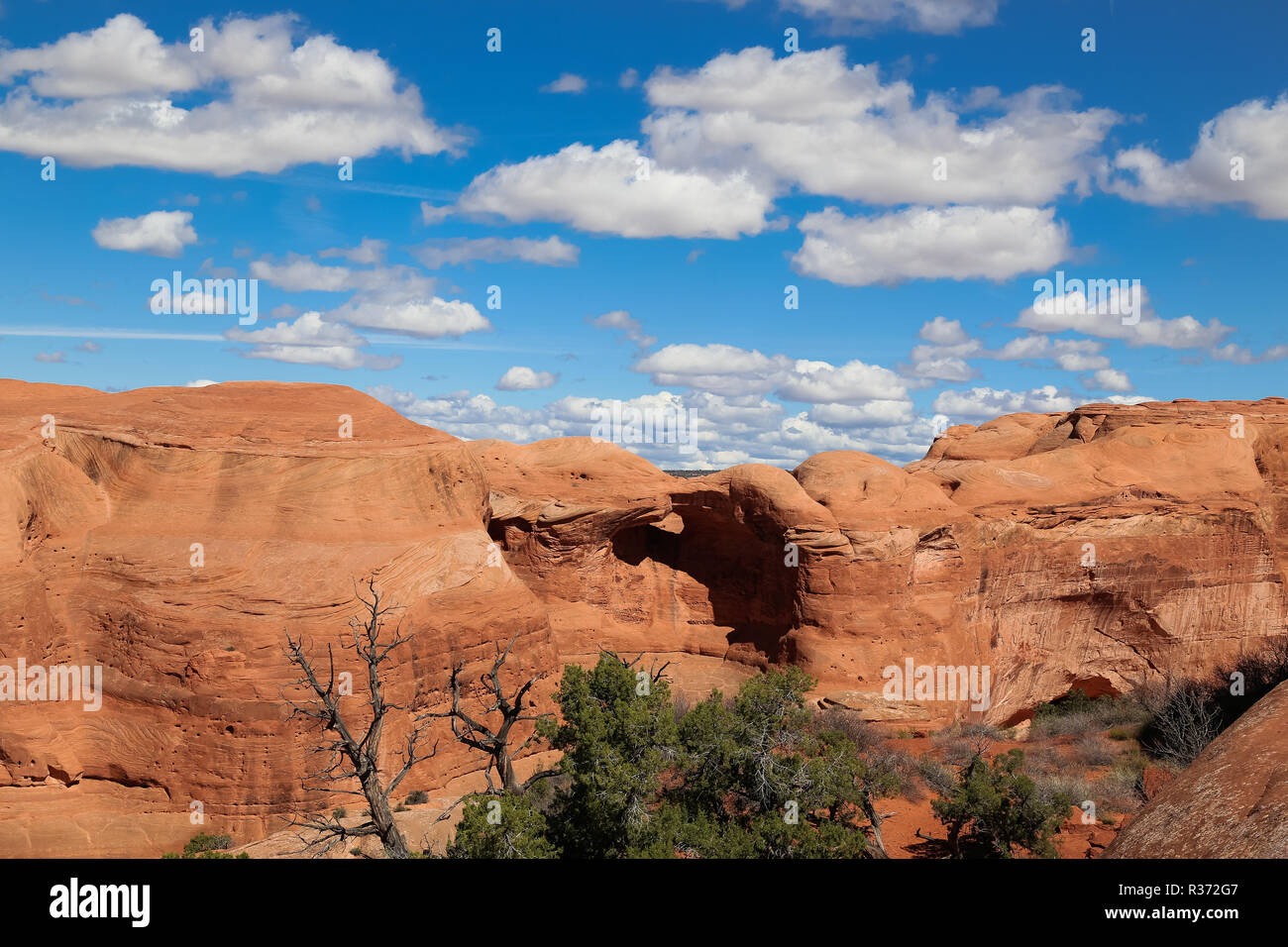 blue sky and small white clouds over arches national park in the utah ...