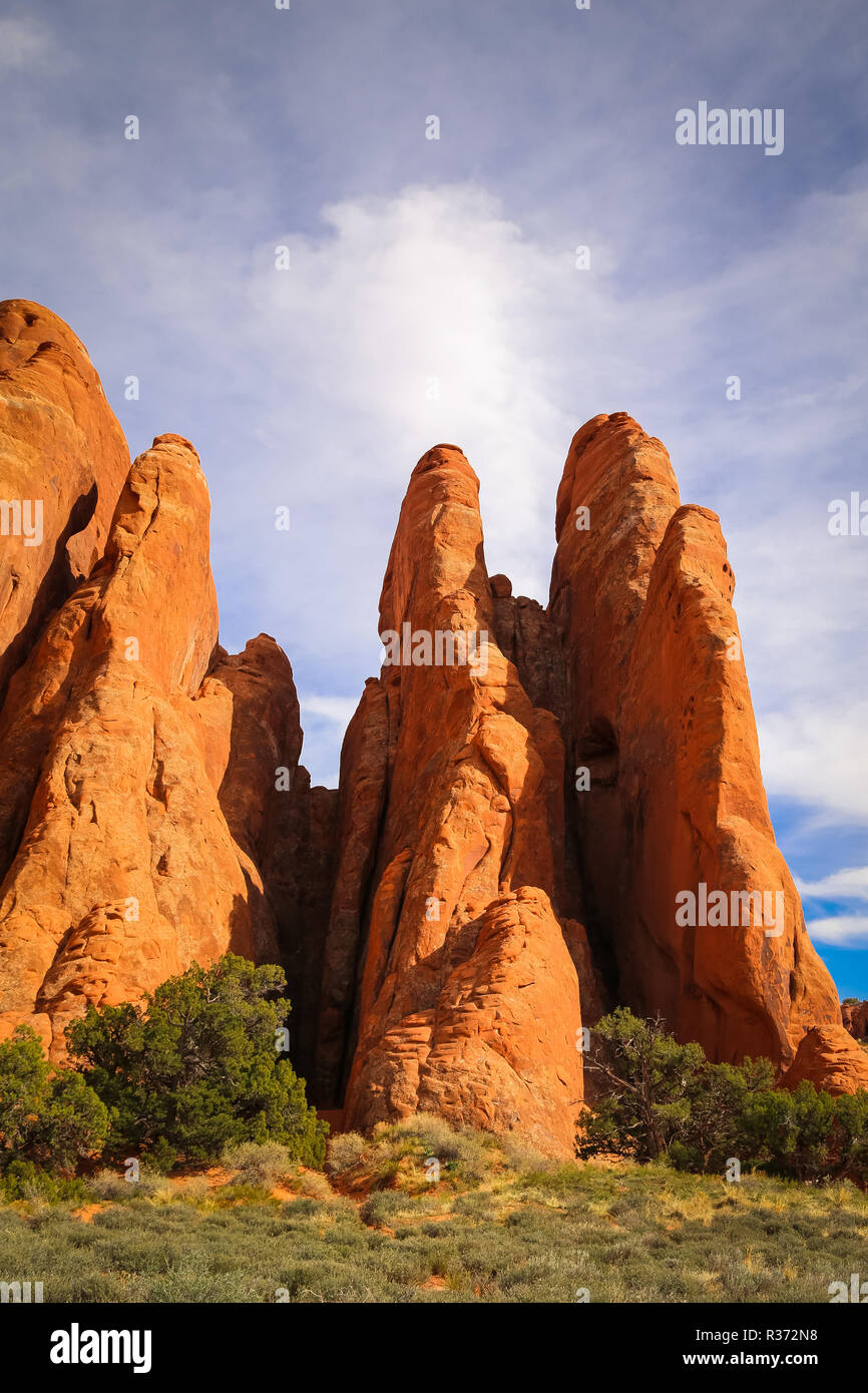 sun behind rocks in arches national park in the utah desert Stock Photo ...